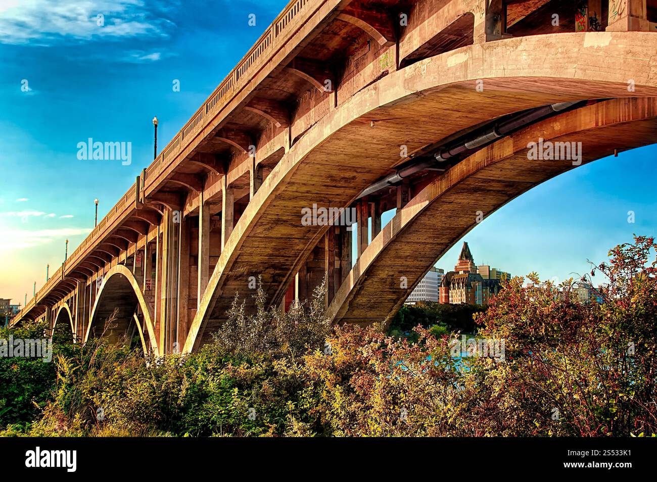A bridge with a city in the background. The bridge is brown and the sky ...