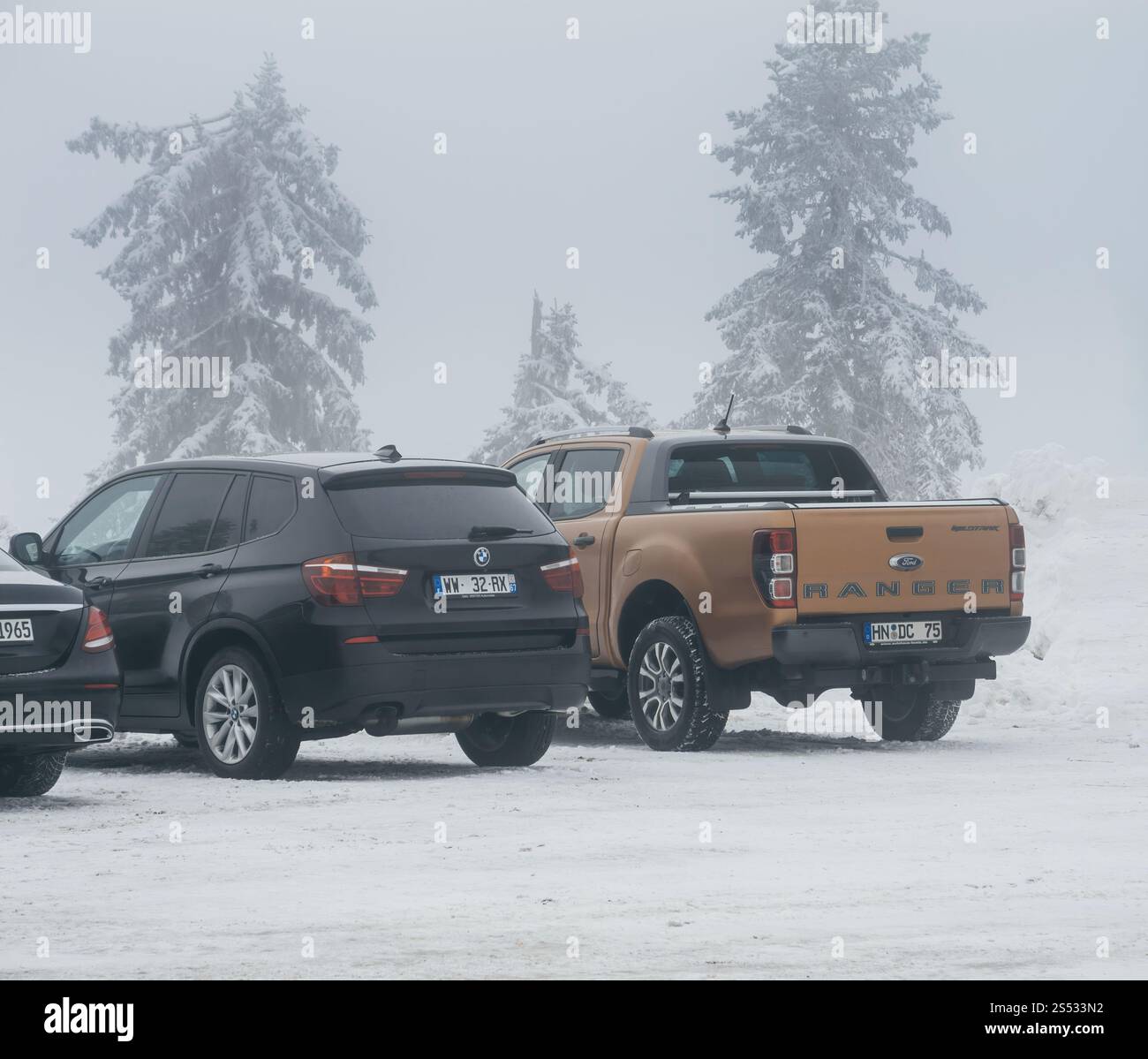 Black Forest, Germany - Jan 3, 2025: Black BMW SUV and golden Ford ...
