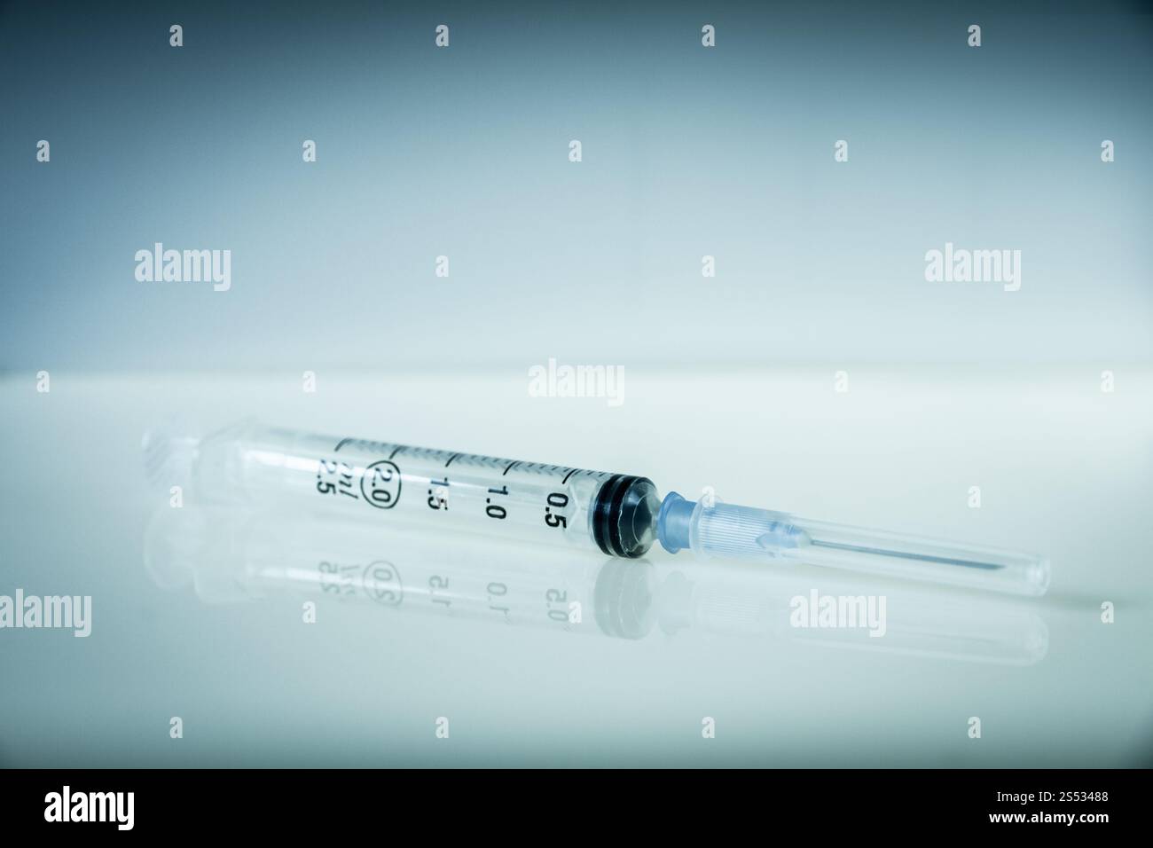 Injection syringe on a clean grey background. Syringe on grey ...