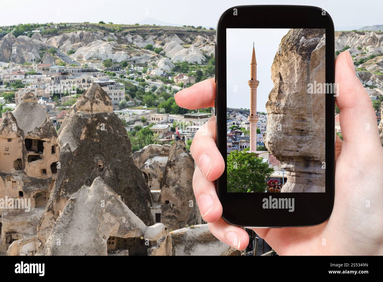 travel concept - tourist photographs of wall of ancient rock-cut house ...
