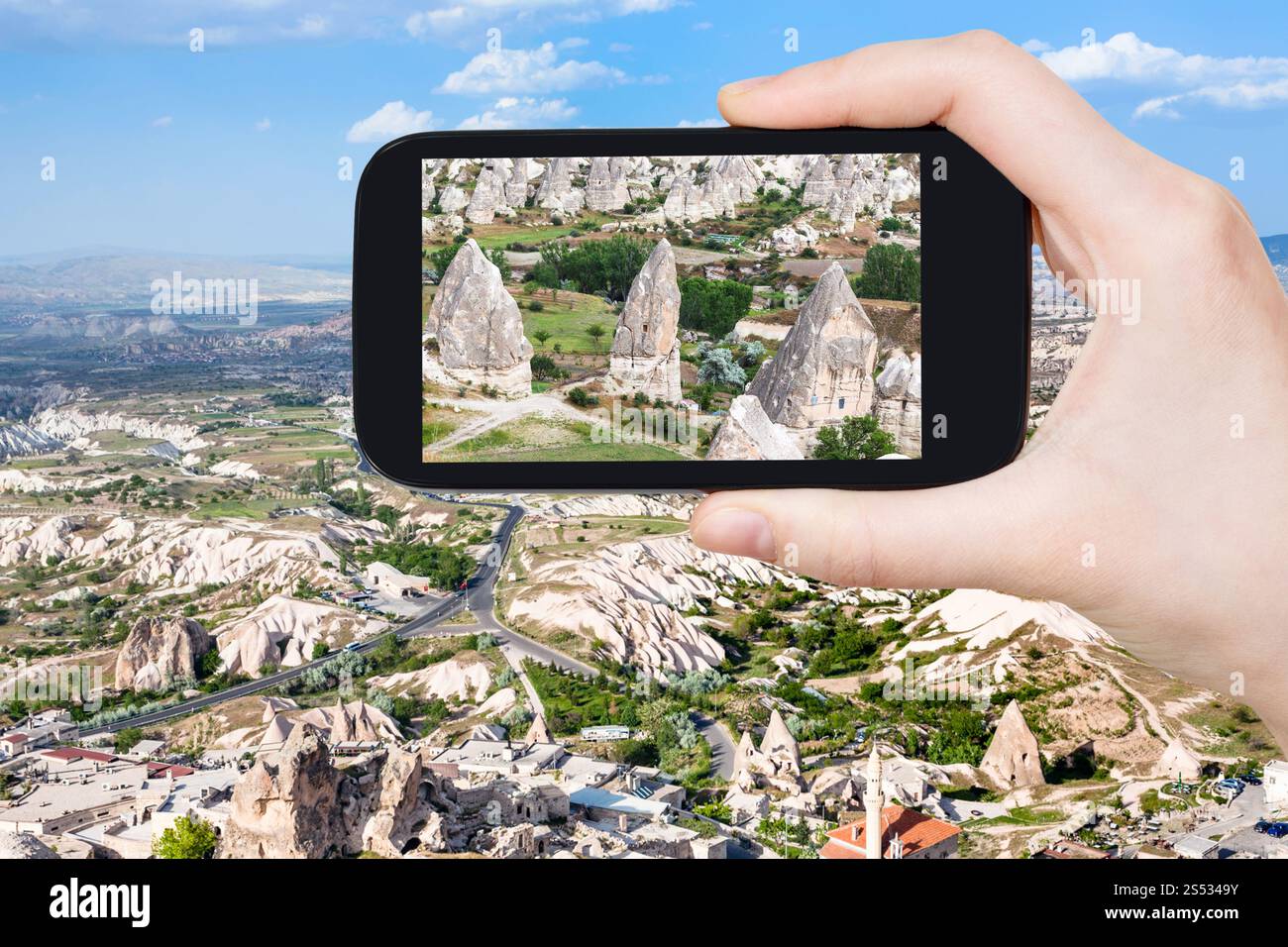 travel concept - tourist photographs of ancient houses in fairy chimney ...