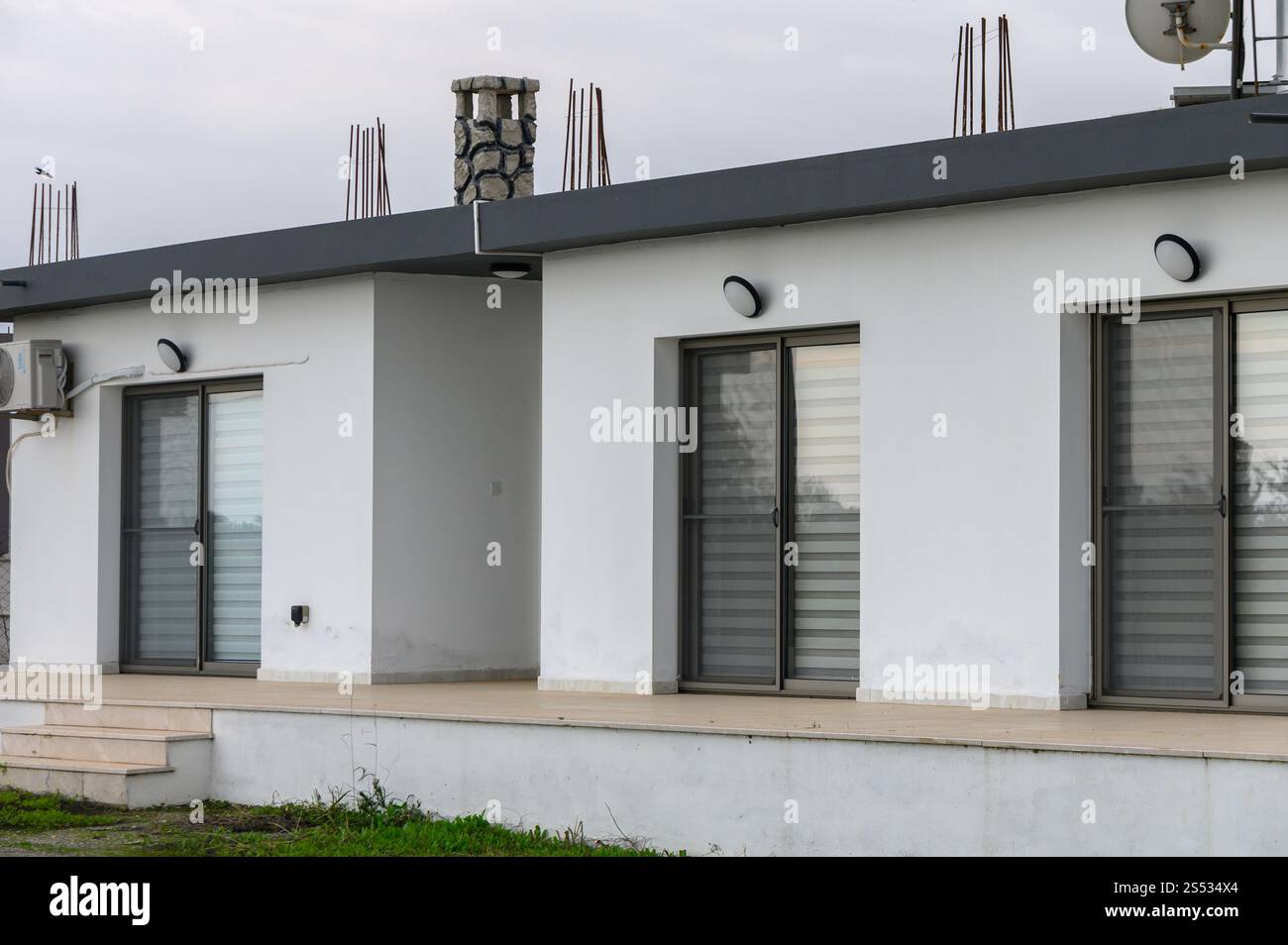 Simple and elegant structure features large windows and a clean ...