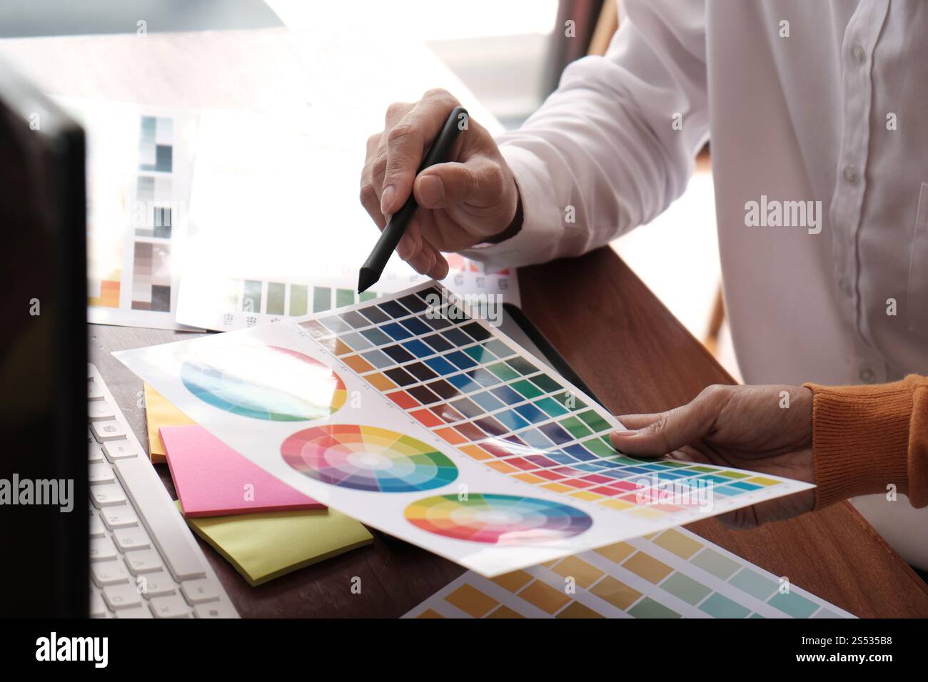 Graphic designer working on digital tablet. artist drawing on graphic tablet and Color swatch ...