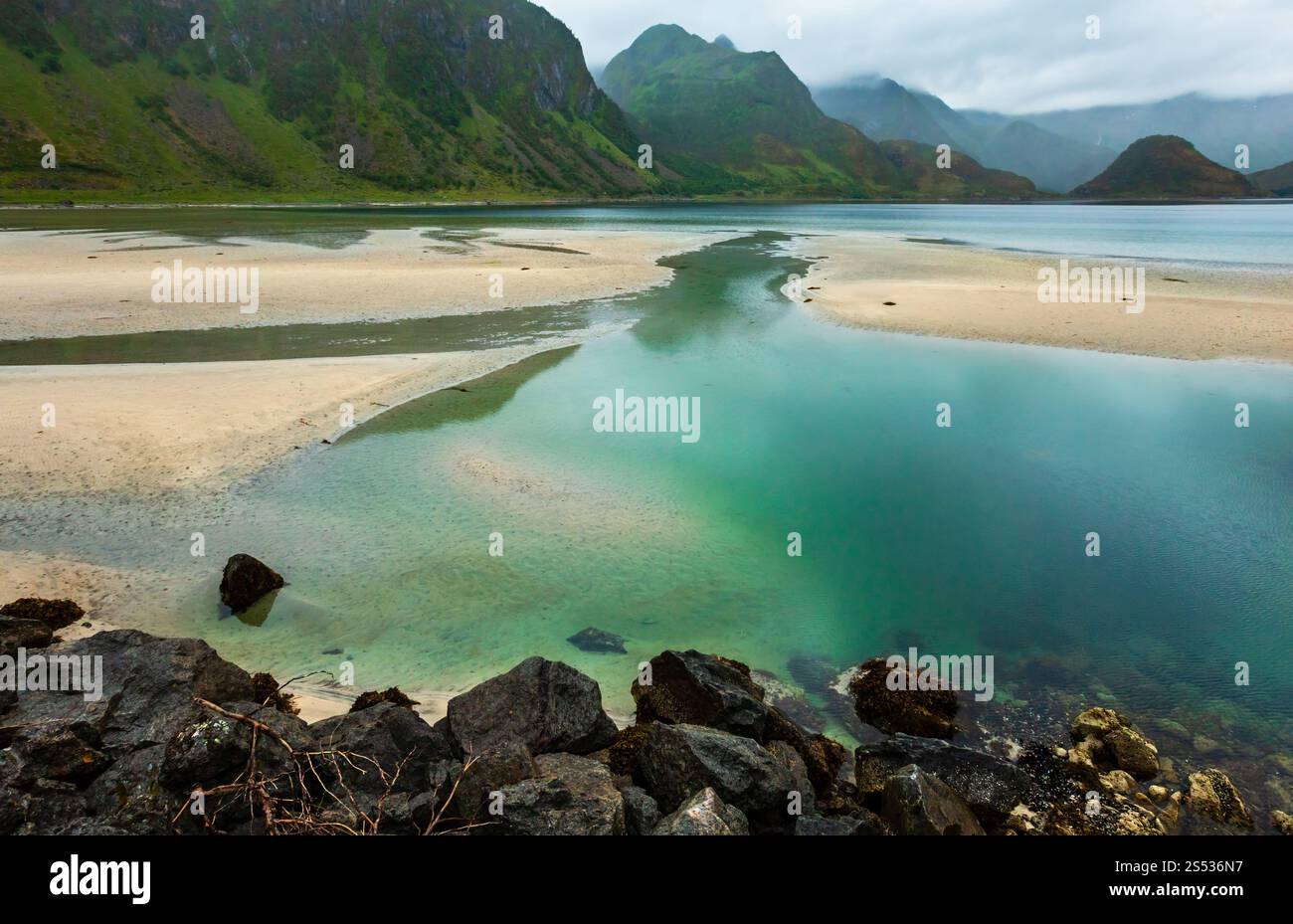 Lofoten fjords and lakes cloudy landscape with sandy beach, lough, and ...