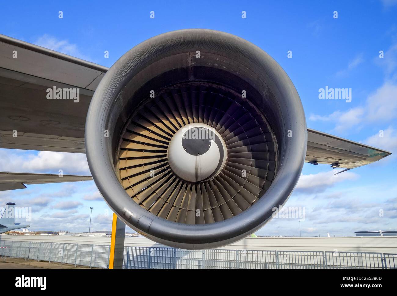 Airplane engine and wing on airport tarmac. Blue sky. Airplane engine ...