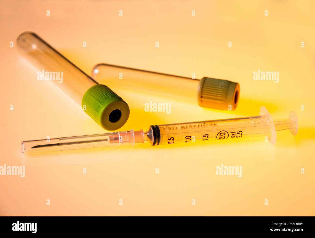 Empty blood test tubes and syringe isolated on orange background. Empty ...