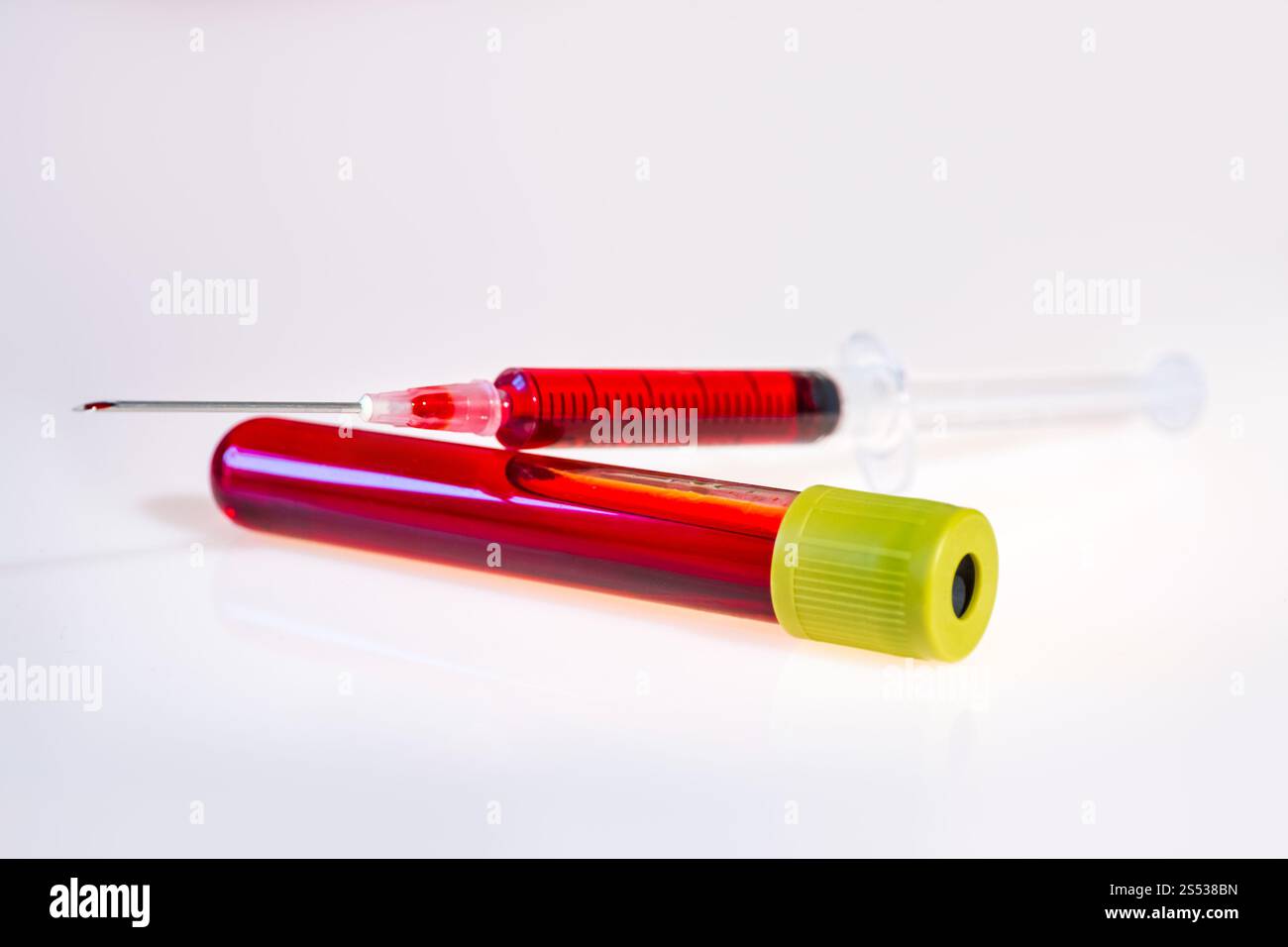 Syringe and test tube with blood isolated on white background. Syringe ...