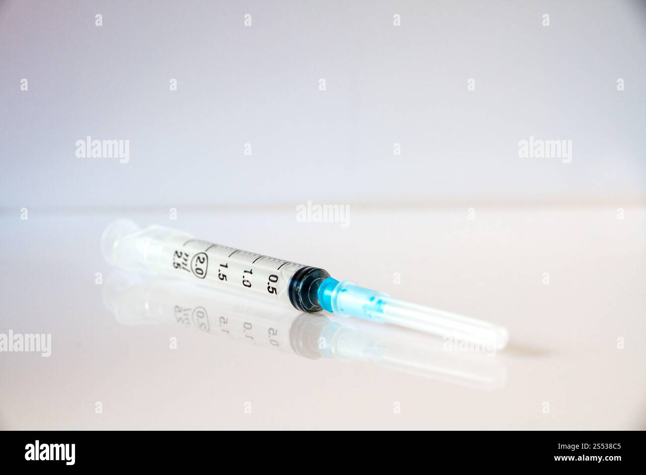 Injection syringe on a clean grey background. Syringe on grey ...