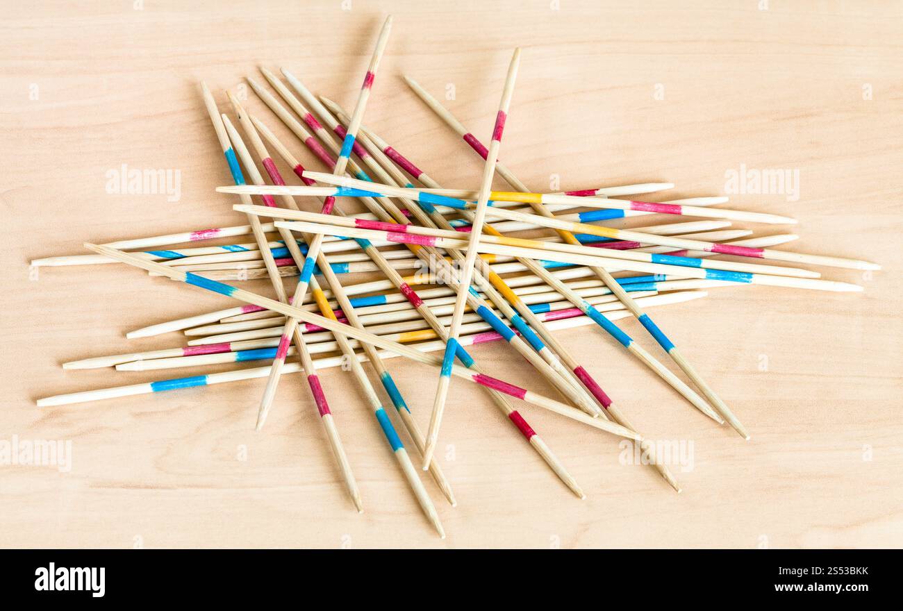 pile from wooden sticks of Mikado pick-up sticks game on wood board ...