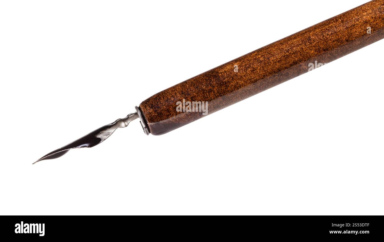 side view of nib filled by black ink in brown dip pen close up isolated ...