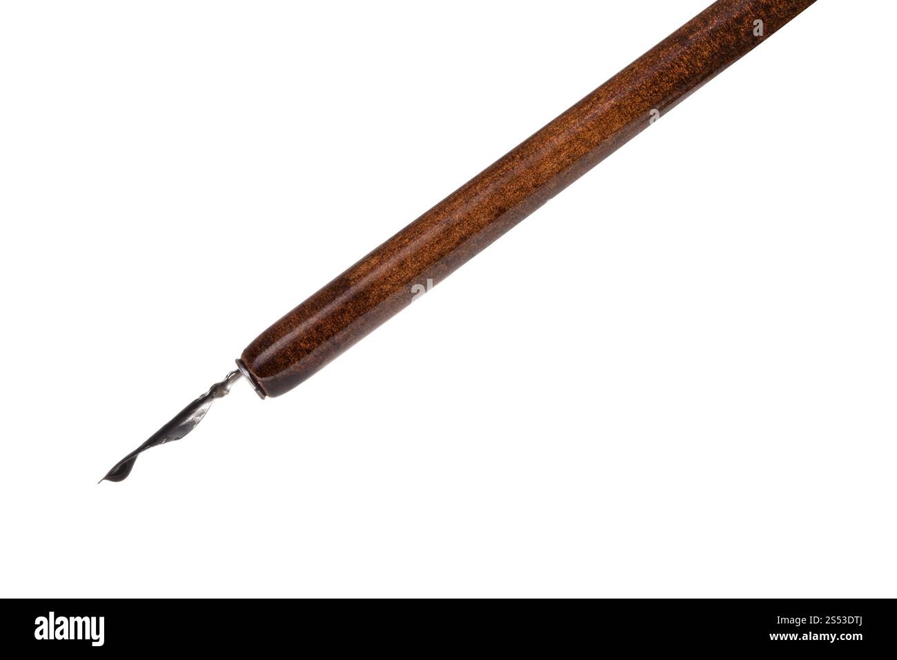 side view of black ink drop in nib of brown dip pen close up isolated ...