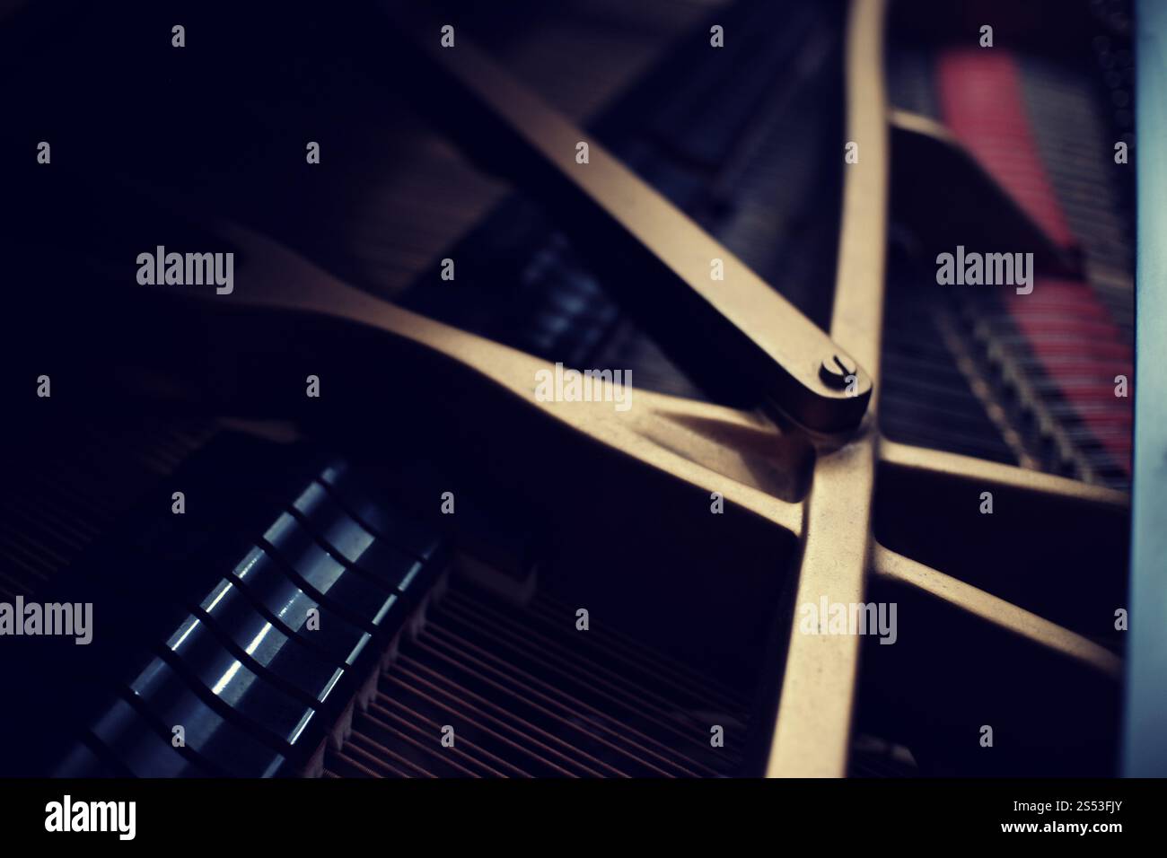 internal parts of an upright piano strings and a tuning key on the pins ...
