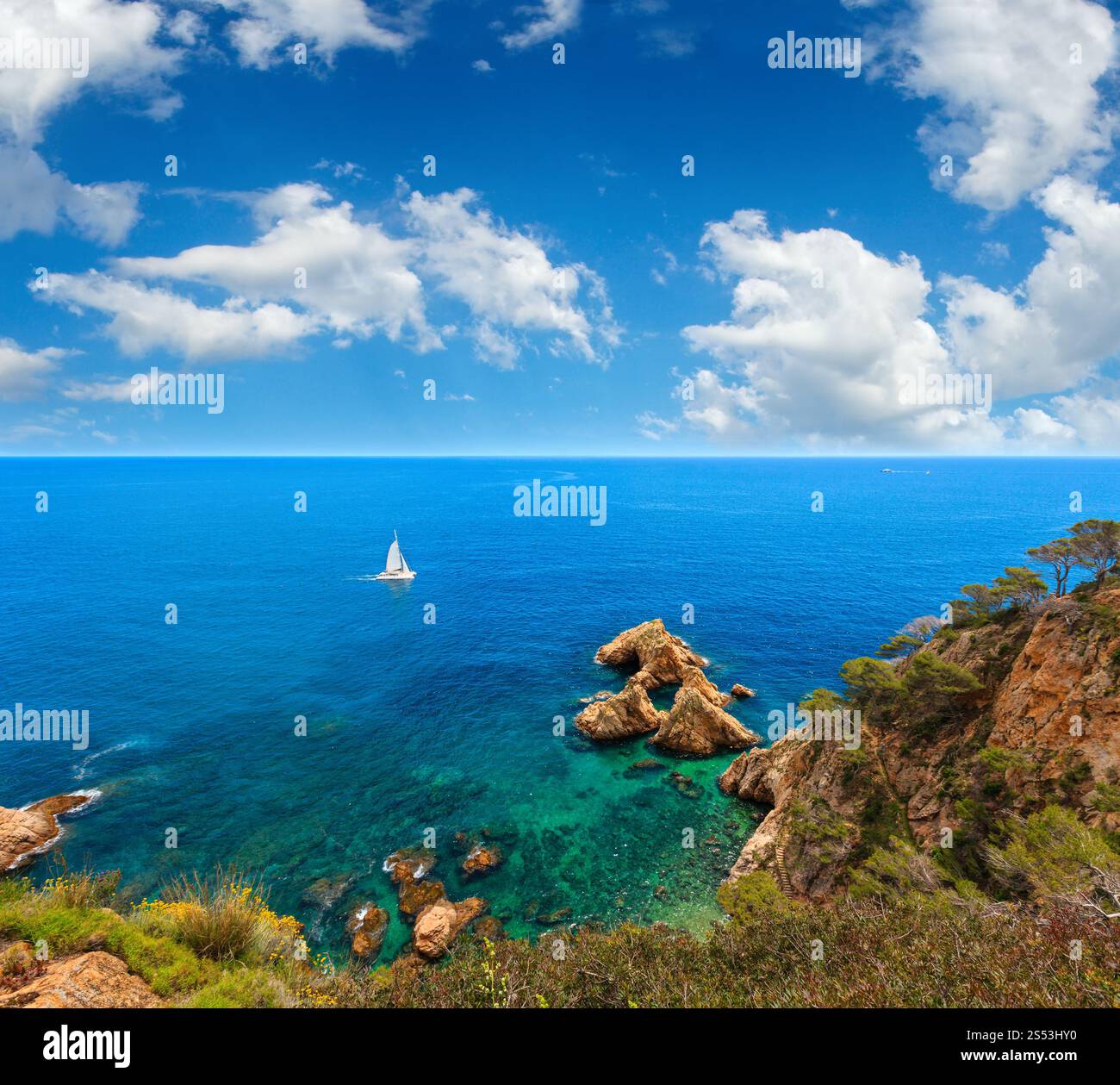 Summer sea rocky coast landscape with sailing catamaran, Costa Brava ...