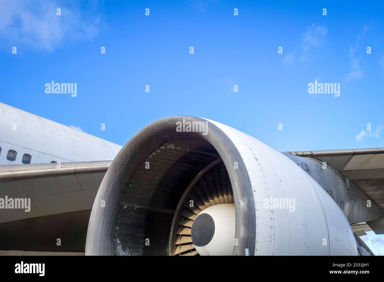 Airplane engine and wing on airport tarmac. Blue sky. Airplane engine ...