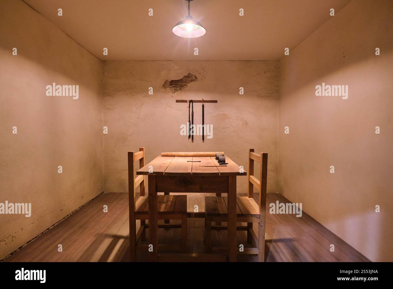 A torture room with clamps, fingernail torture tools, rope and desk. At ...