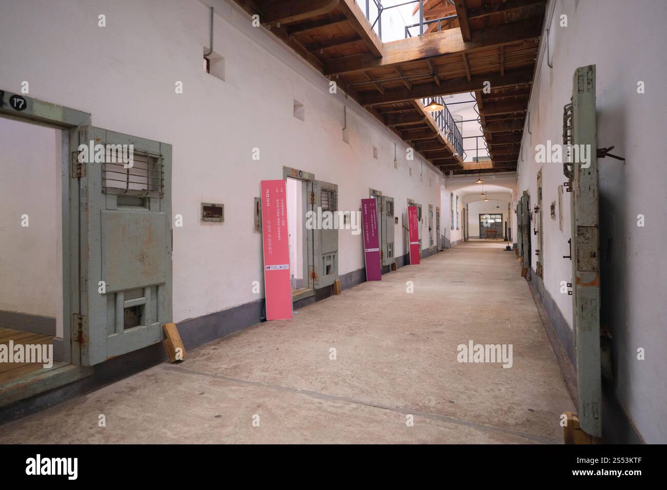 View of a typical multistory, catwalk, cell wing with wood doors. At ...