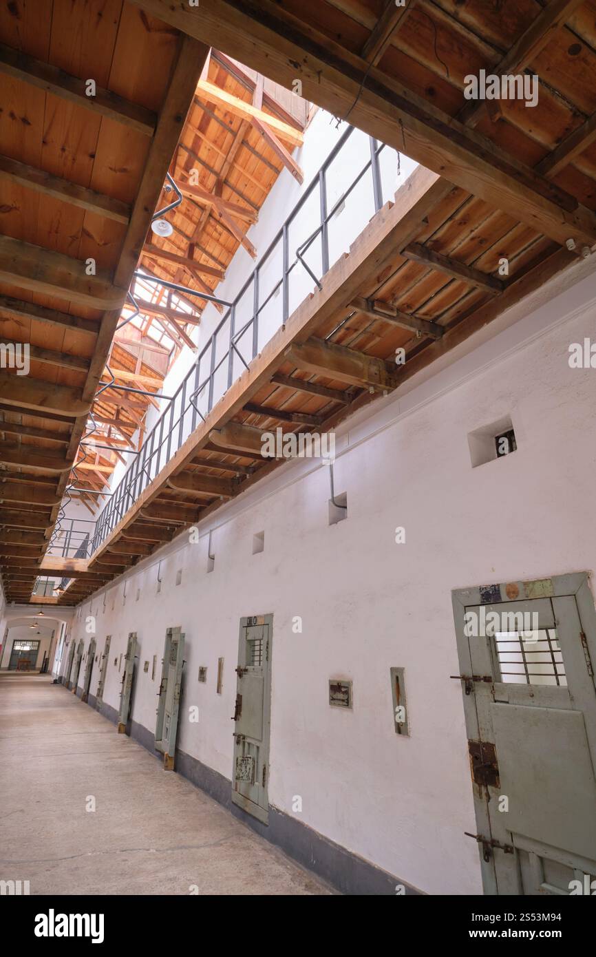 View of a typical multistory, catwalk, cell wing with wood doors. At ...