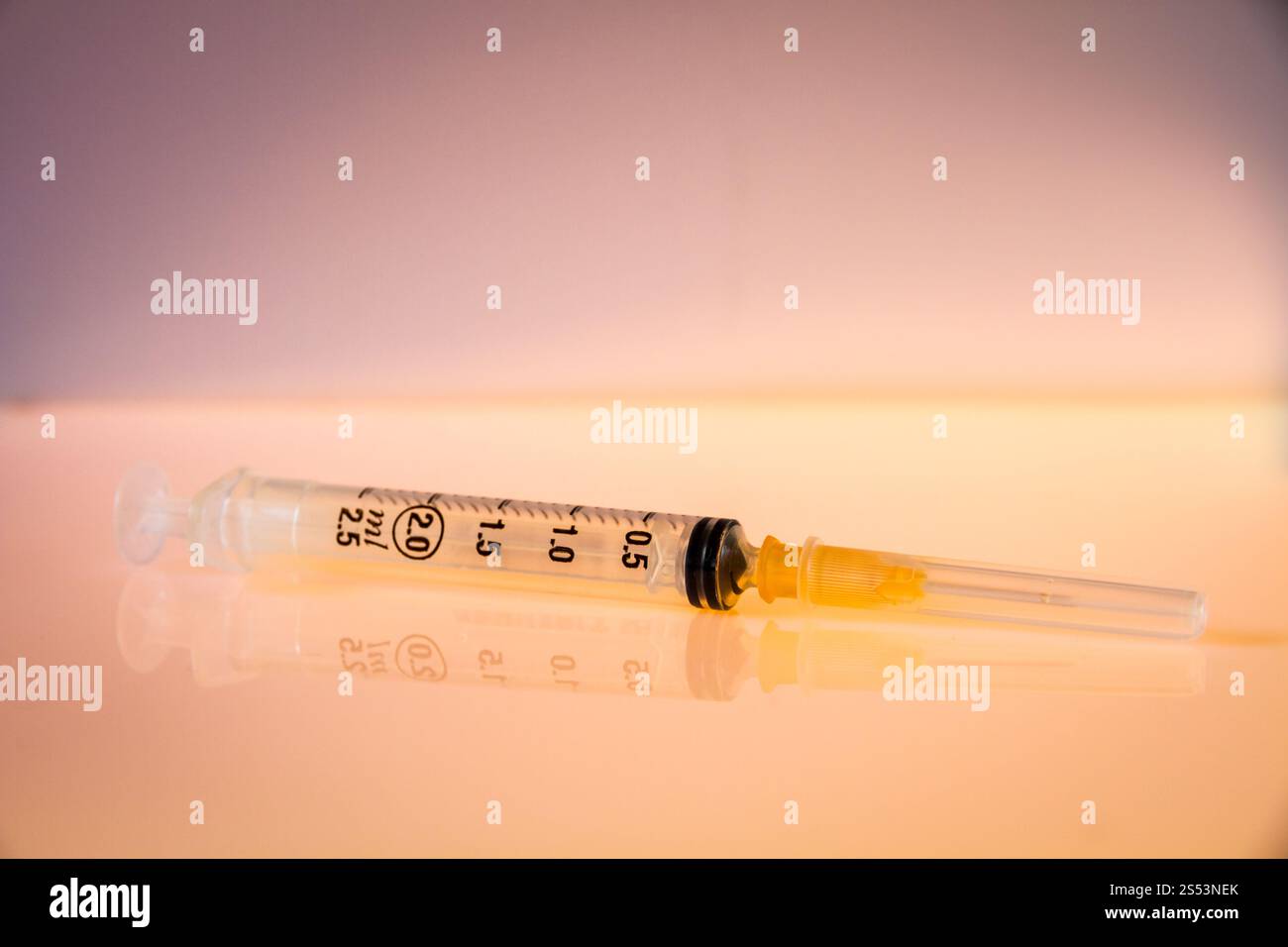 Injection syringe on a clean orange background. Syringe on orange ...