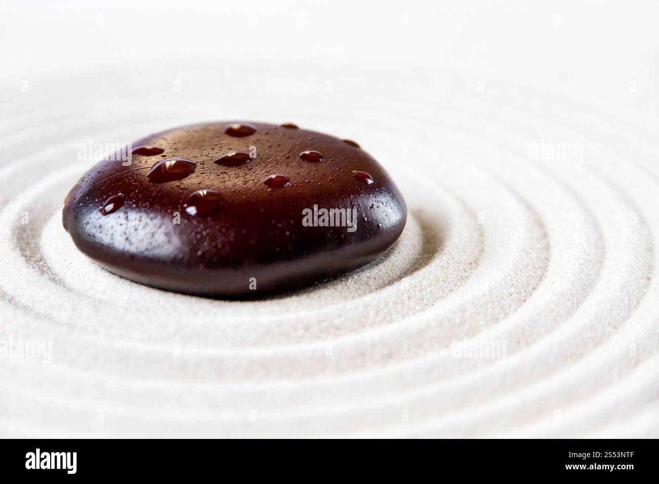 Wet black stone in the sand. Zen japanese garden background scene. Zen ...