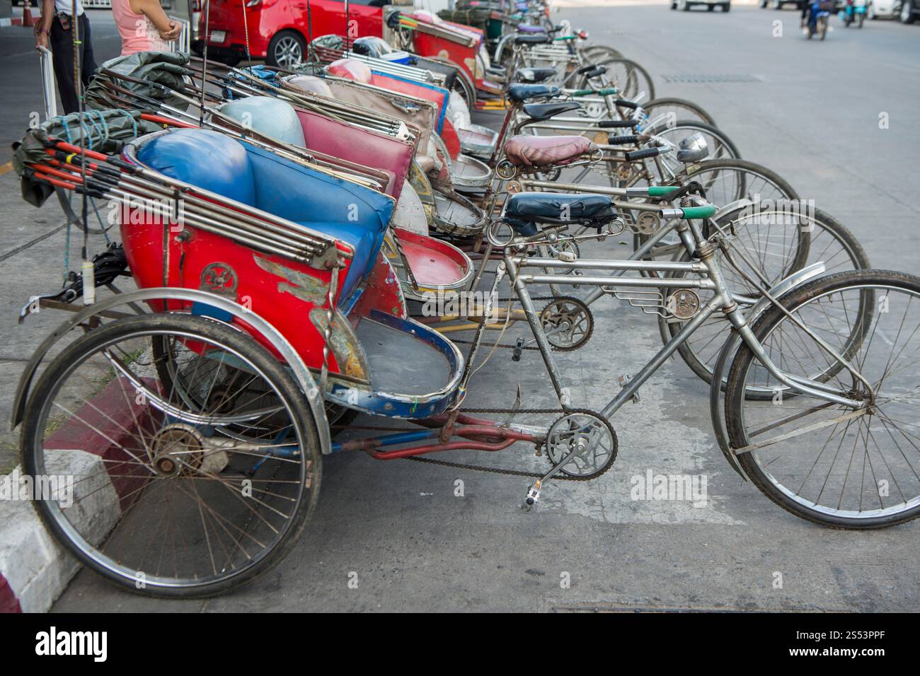 a riksha or bicycle taxi at a road in the city of Phitsanulok in the ...