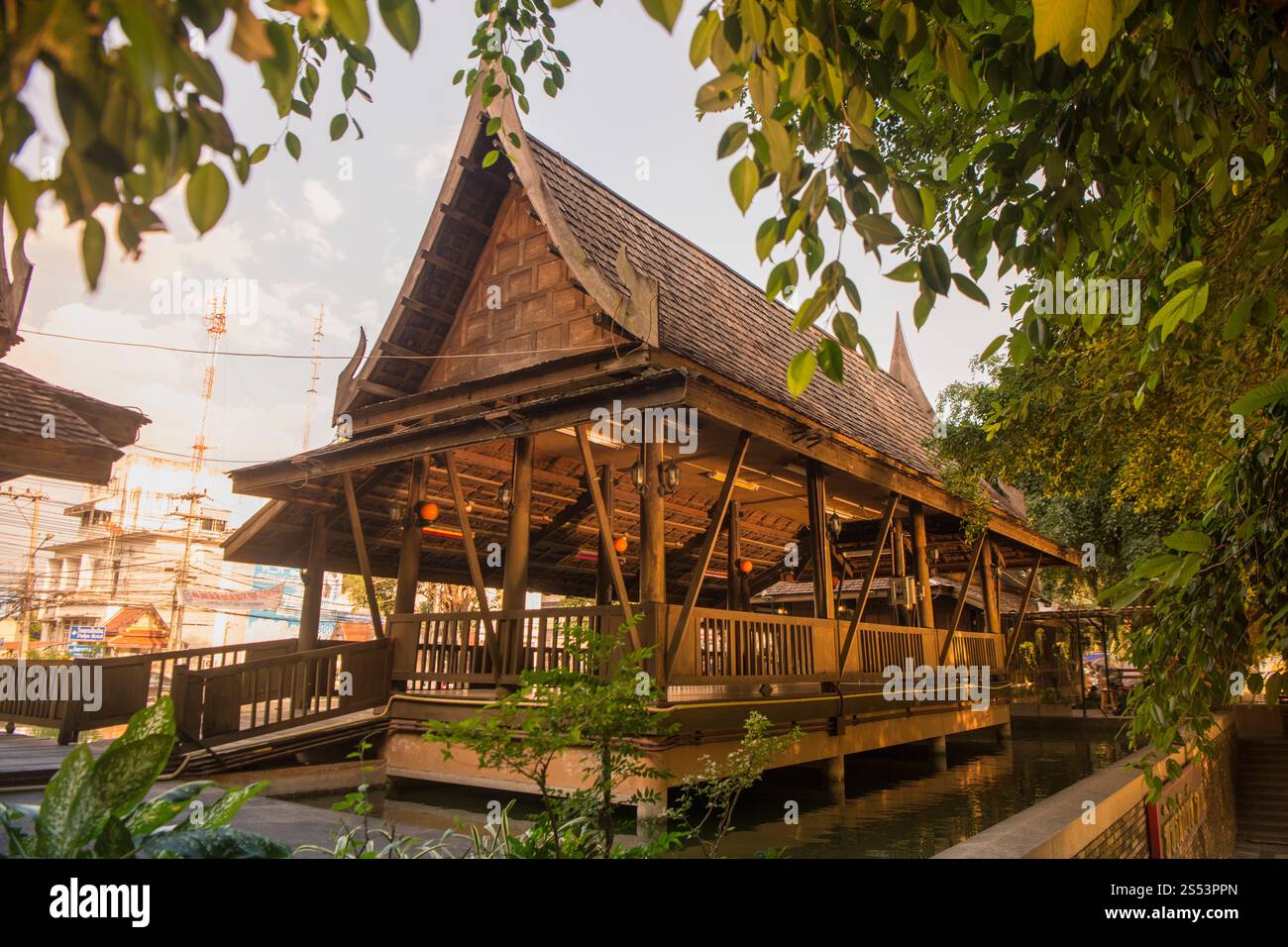 a traditional thai woodhouse with garden at the Maenam river in the ...
