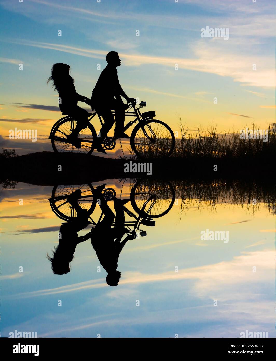 silhouette of couple driving bike happy time sunset Stock Photo - Alamy