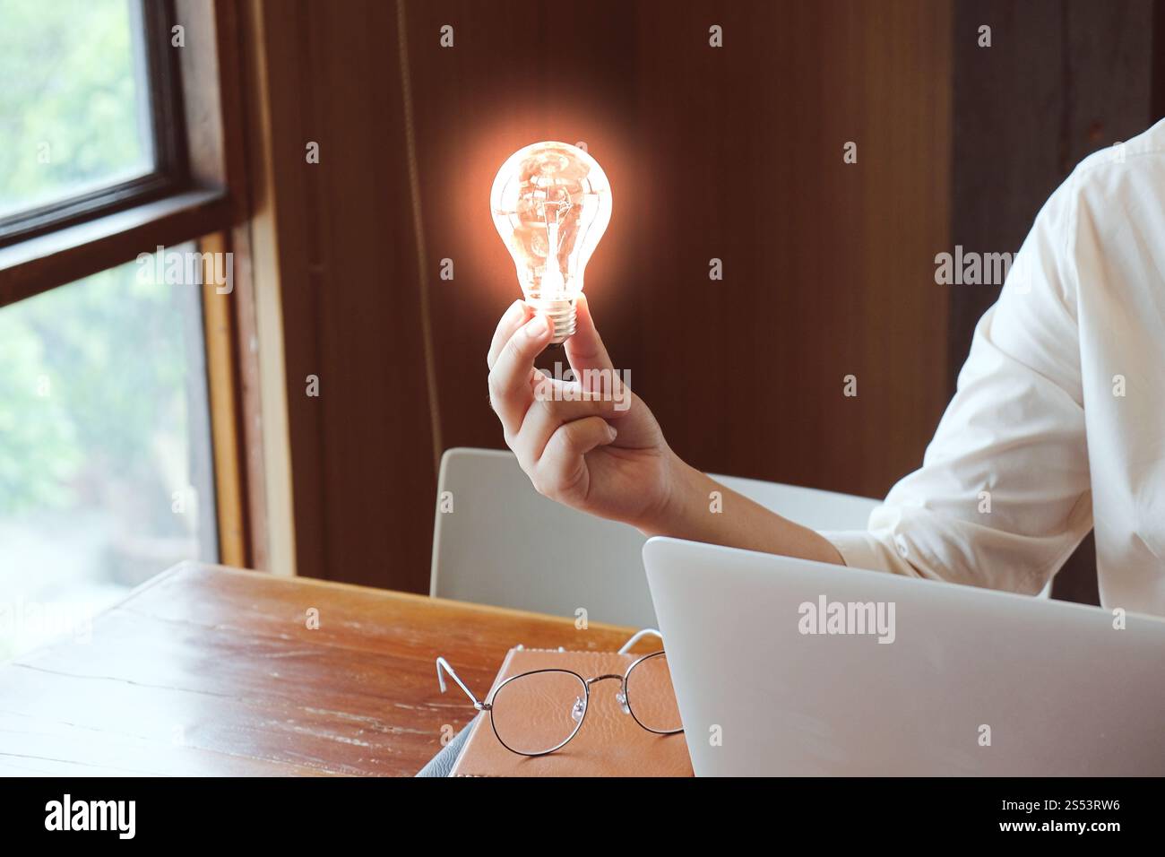 Idea of business person holding light bulb concept creativity with ...