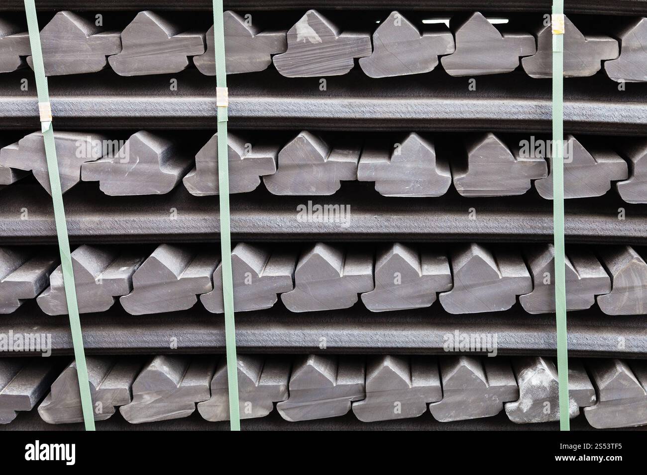 construction background - stockpile of gray rubber retainers for rails ...
