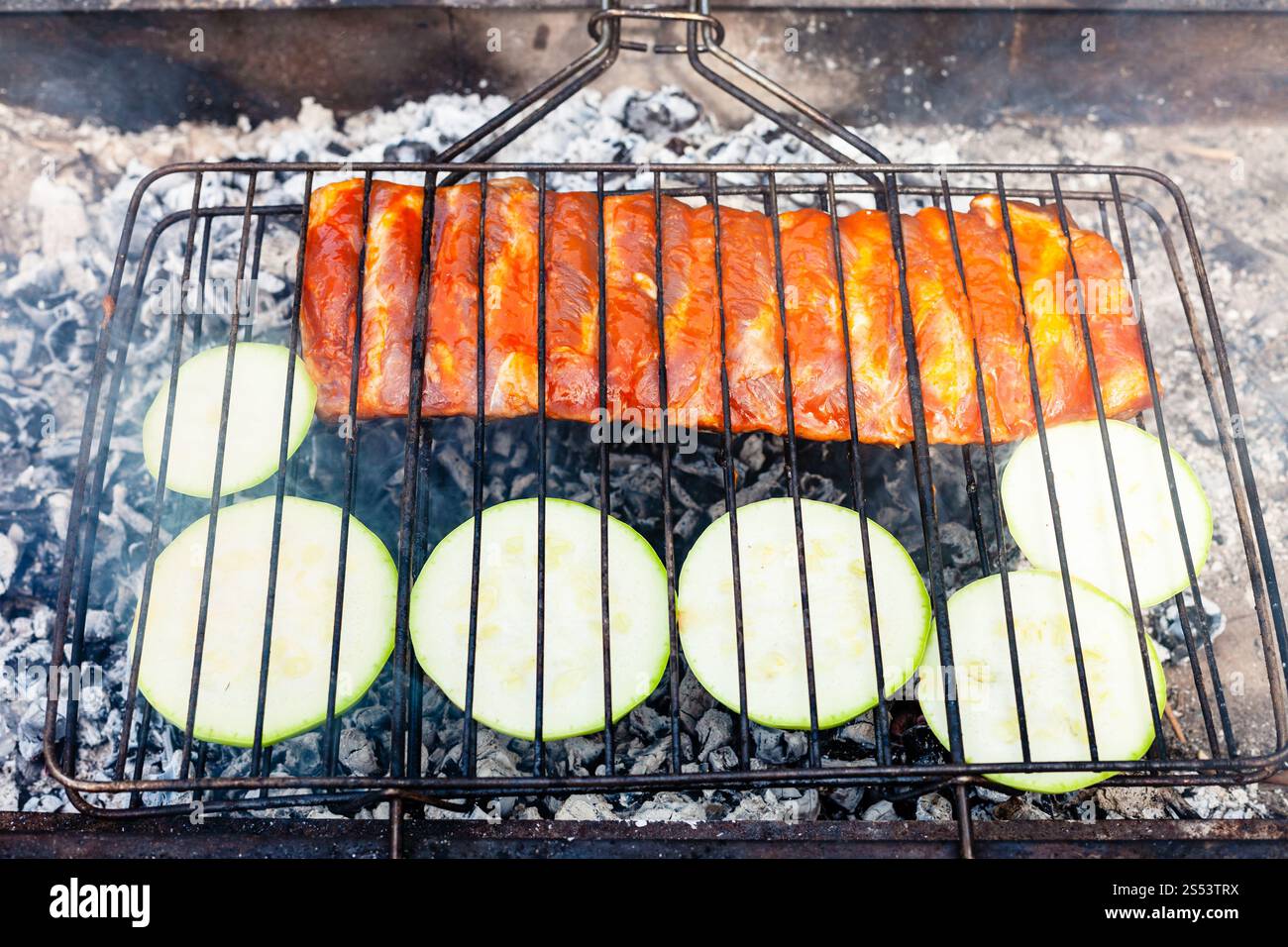 raw pork ribs marinated in sauce with sliced squash vegetable in ...