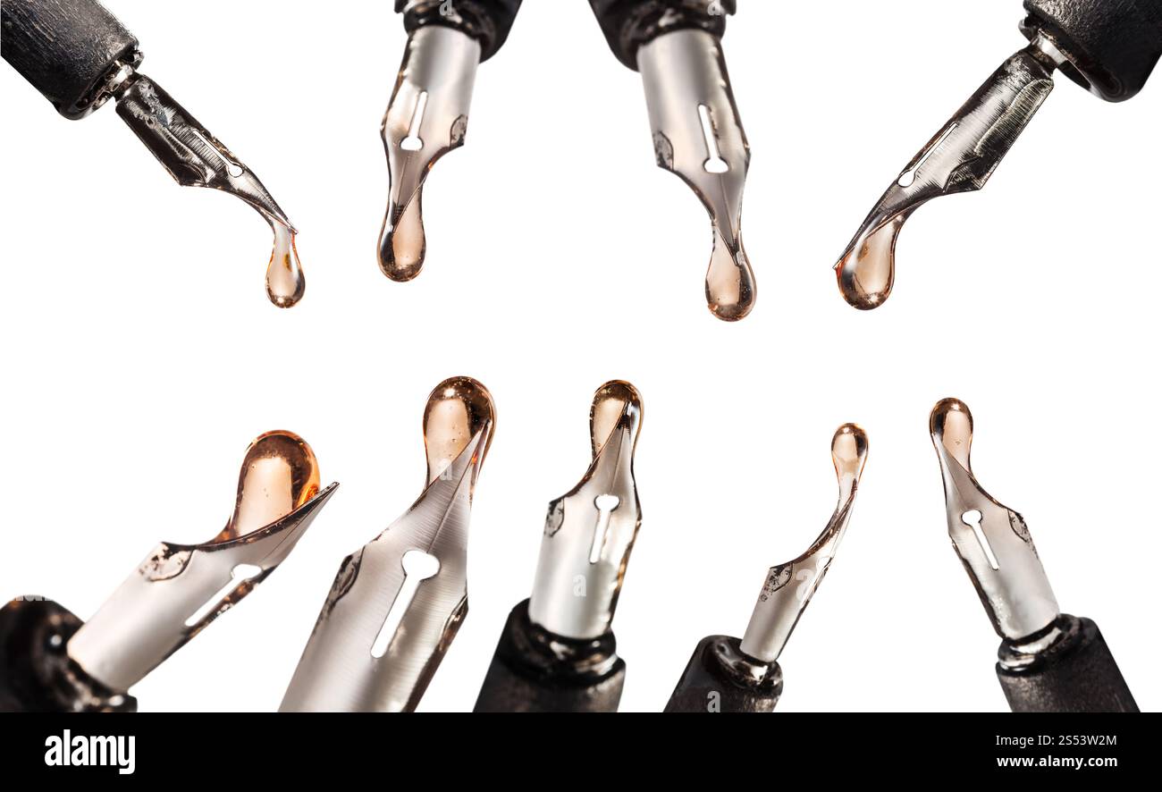 set from steel nibs with pink ink drops close up on dip pen isolated on ...