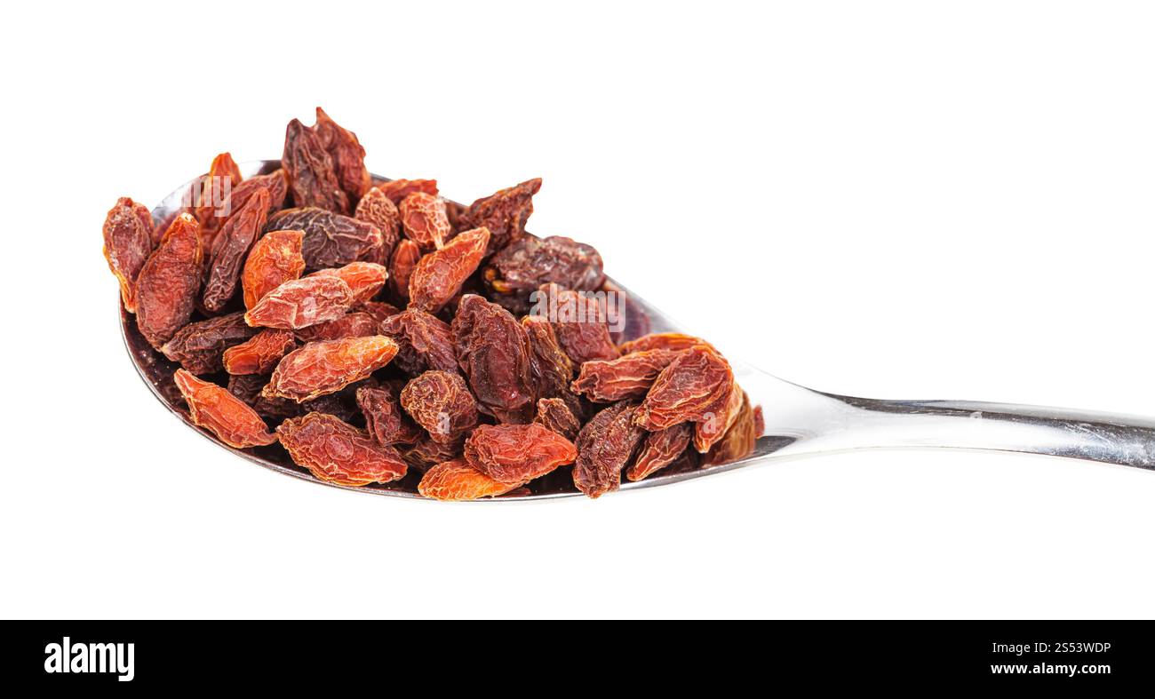 dried goji berries in spoon close-up isolated on white background Stock ...