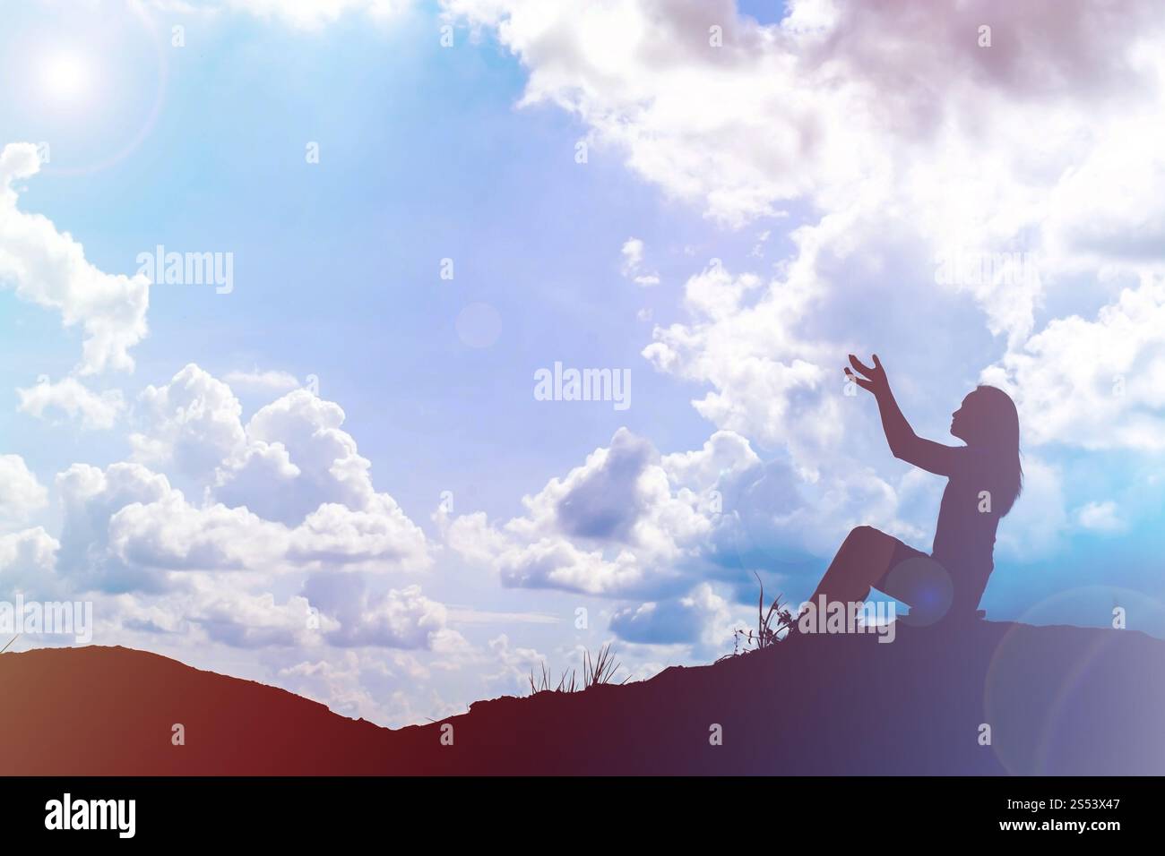 Silhouette of woman praying over beautiful sky background Stock Photo ...