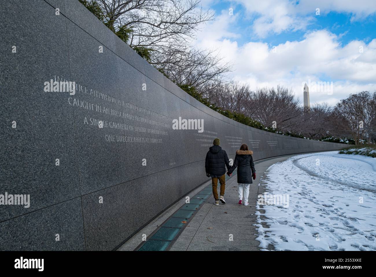 A couple walks by the wall of quotes as part of the Martin Luther King ...
