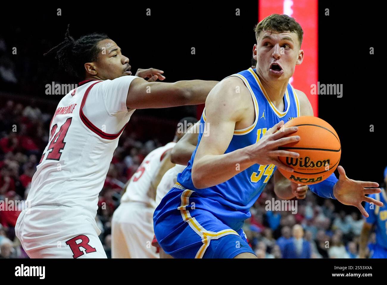 UCLA forward Tyler Bilodeau (34) is guarded by Rutgers center Lathan ...