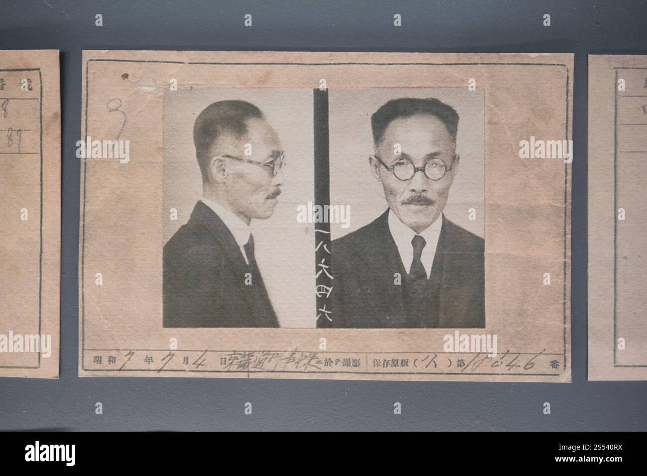 A mug shot, photograph of an activist prisoner with moustache, glasses ...