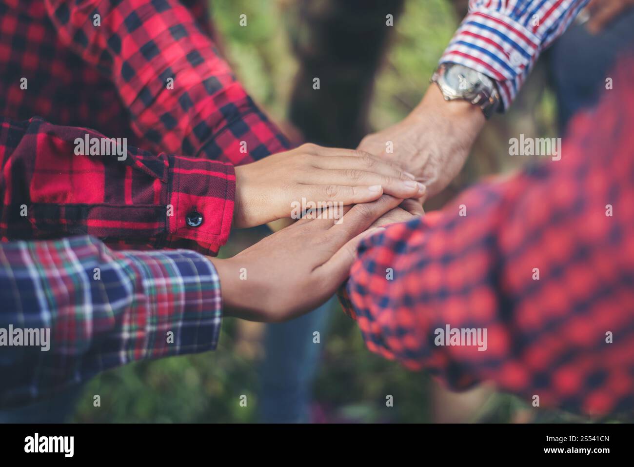 Close up top view of young business people putting their hands together ...
