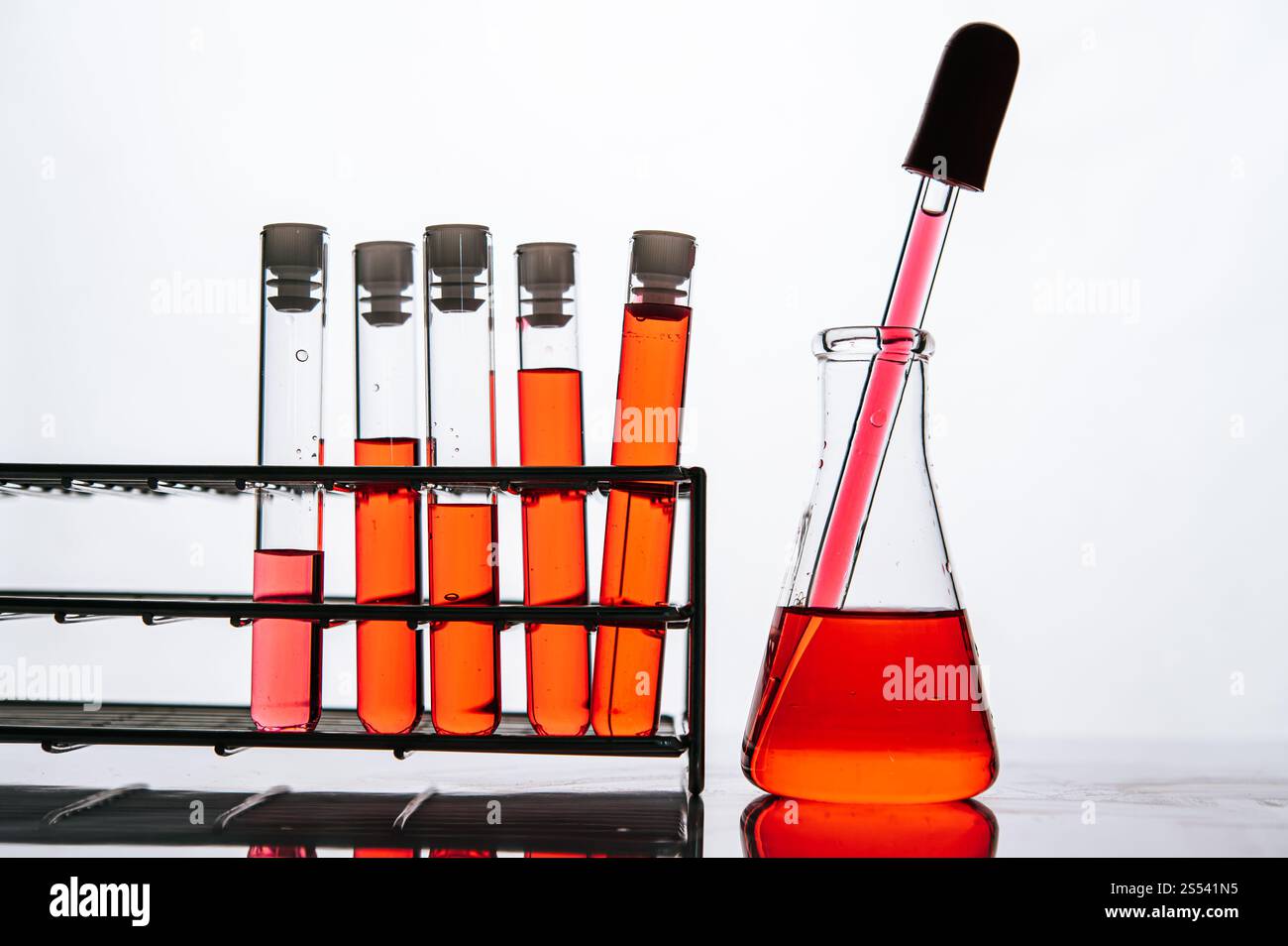 Orange chemicals in a science glass tube arranged on a shelf Stock ...