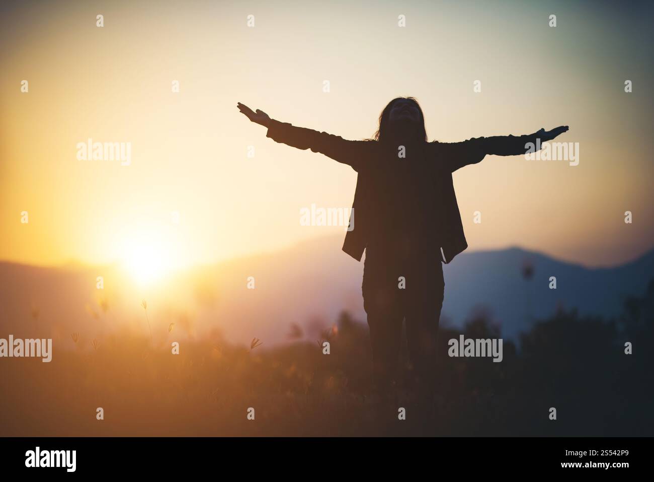 Silhouette of woman praying over beautiful sky background Stock Photo ...