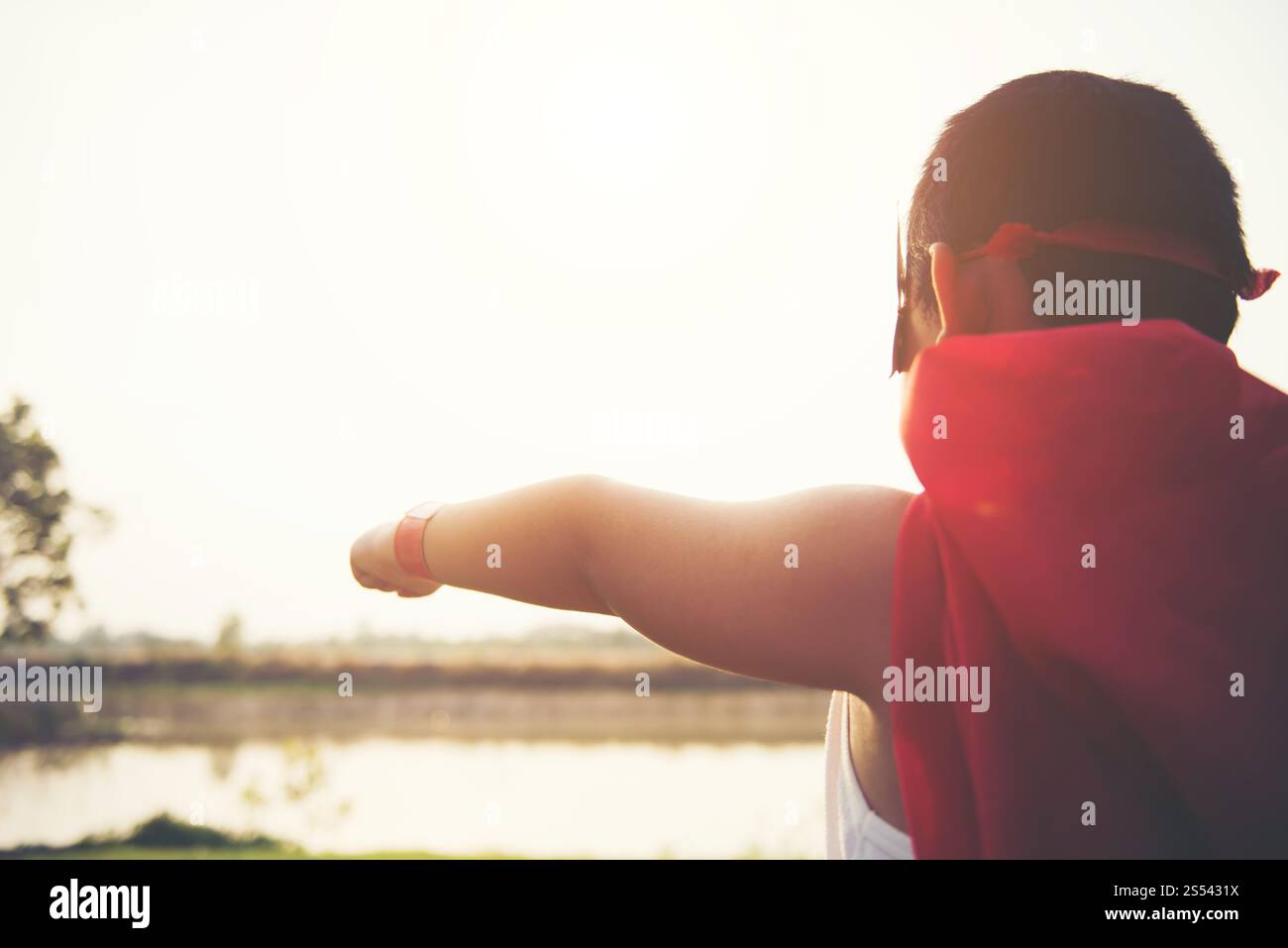 Super boy standing show power strong to fly Stock Photo - Alamy