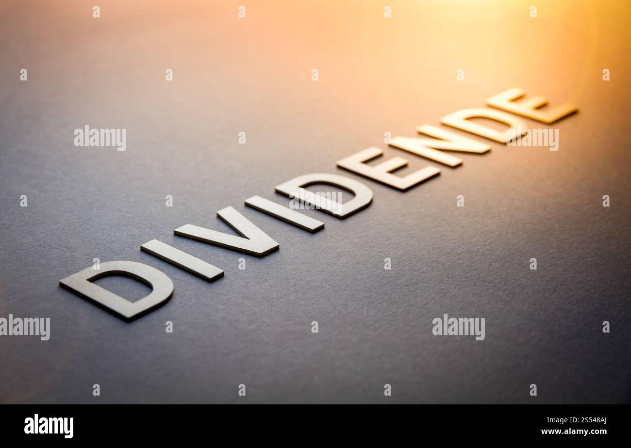 Word dividende written with white solid letters on a board. Word ...