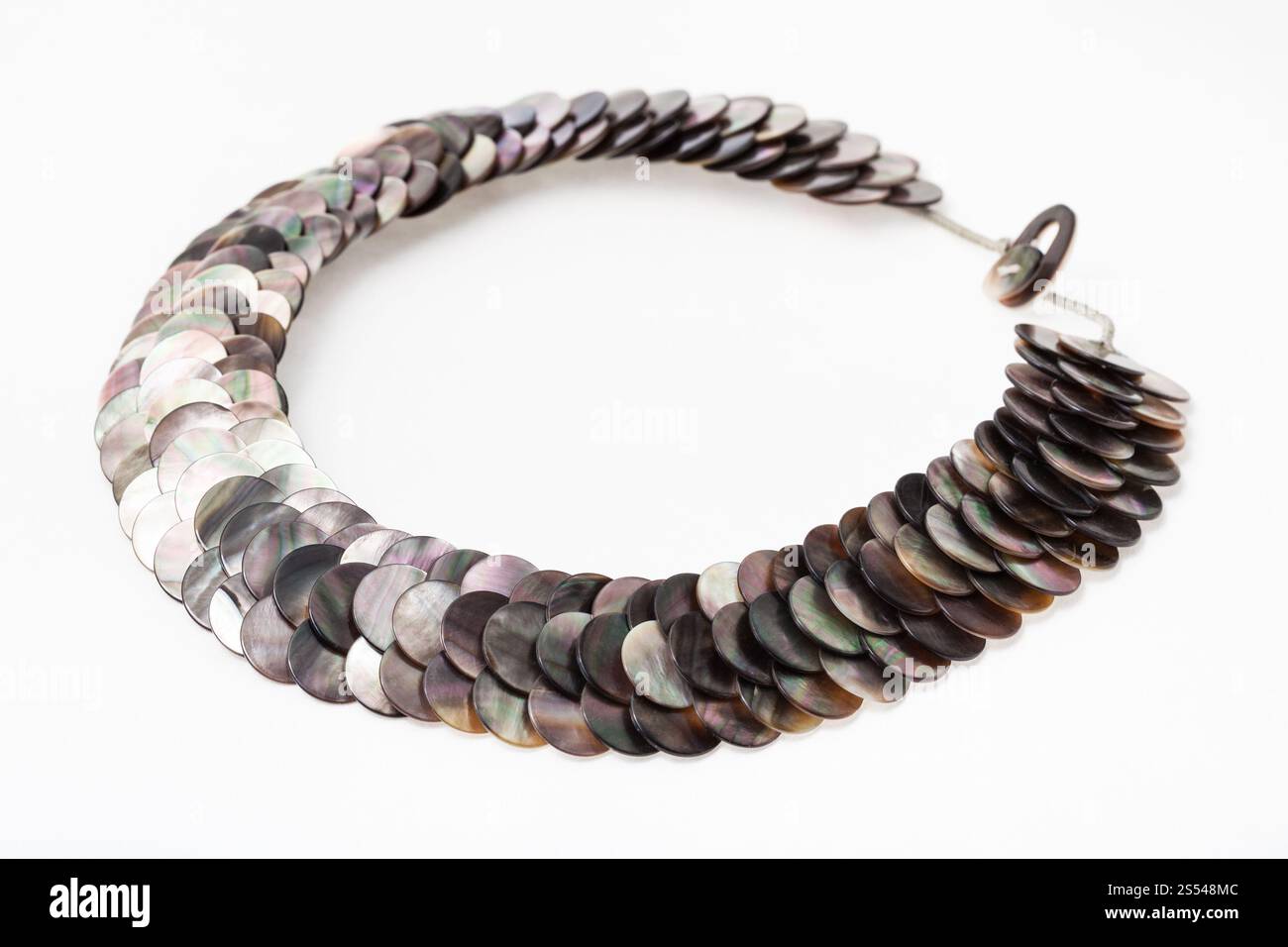 collar from polished natural nacre discs on white paper background ...