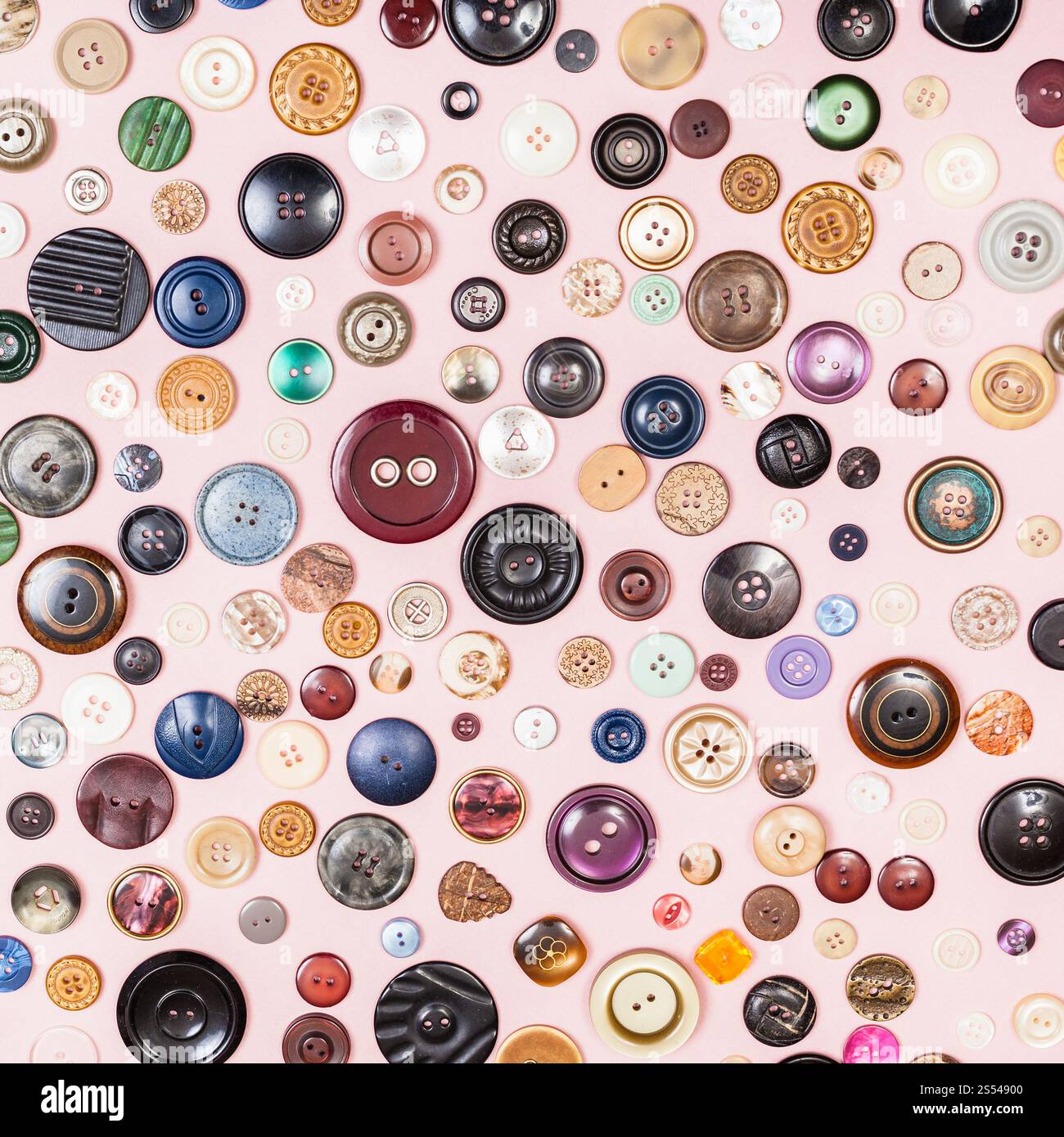 top view of many various buttons on pink background Stock Photo - Alamy