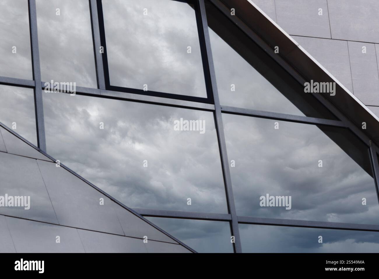 Reflection of an overcast sky in the windows of a modern house Stock ...