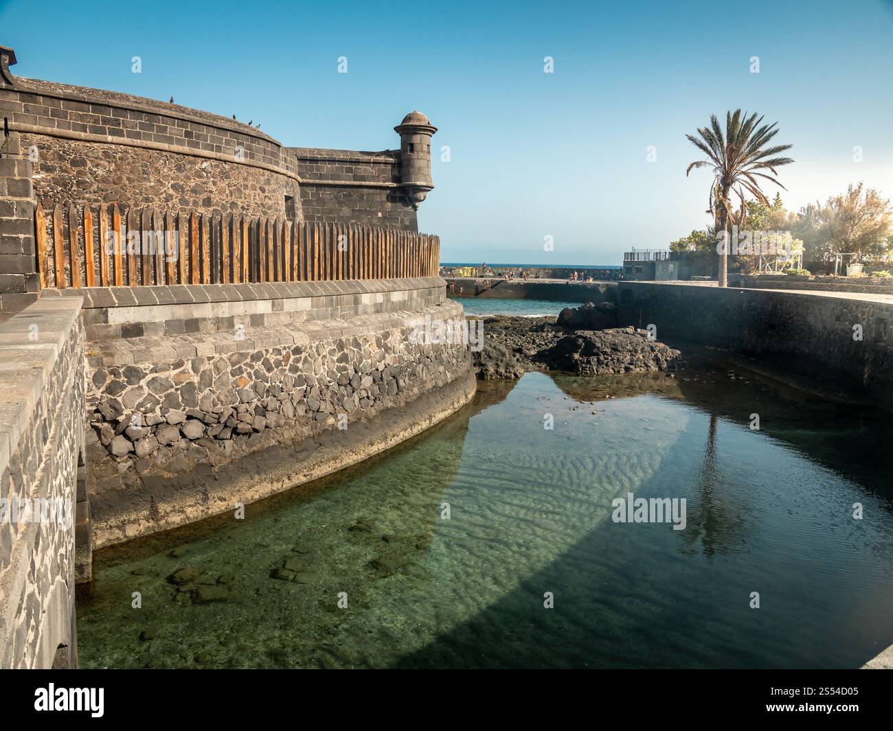 Photo of old stone castle with water moat on the ocean coast. Image of ...