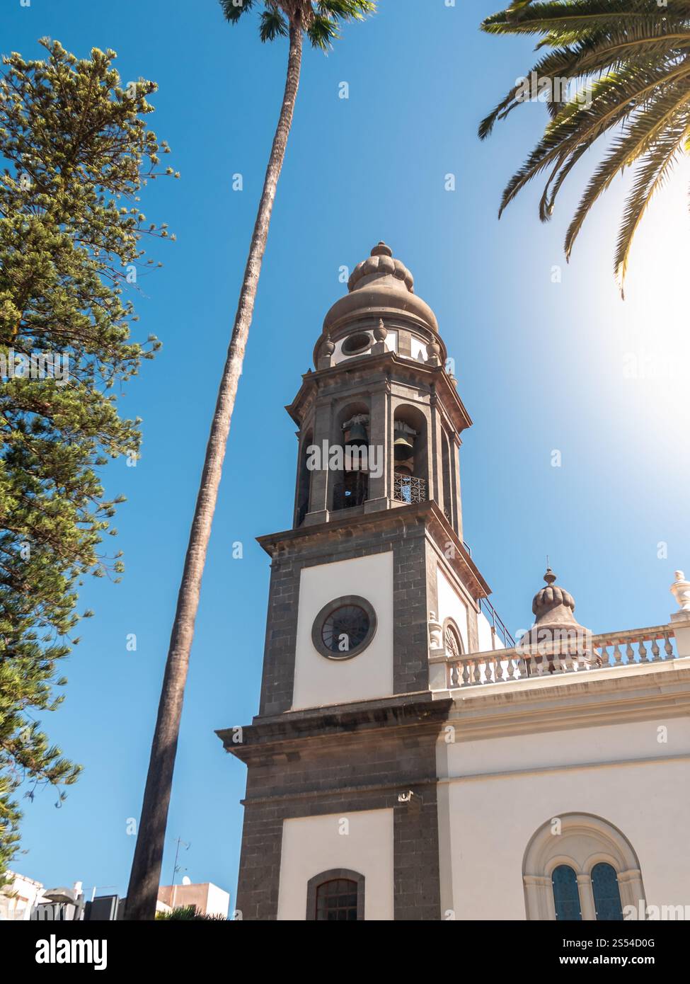 Beautiful photo of high stone catholic church bell tower against blue ...