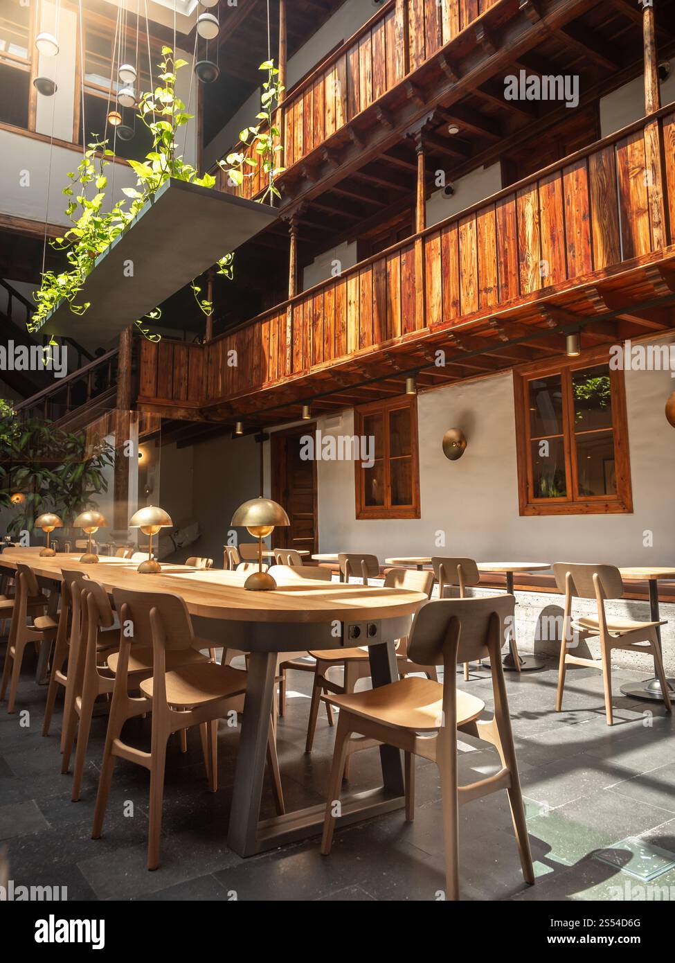Beautiful photo of long wooden table and chairs in inner court of ...