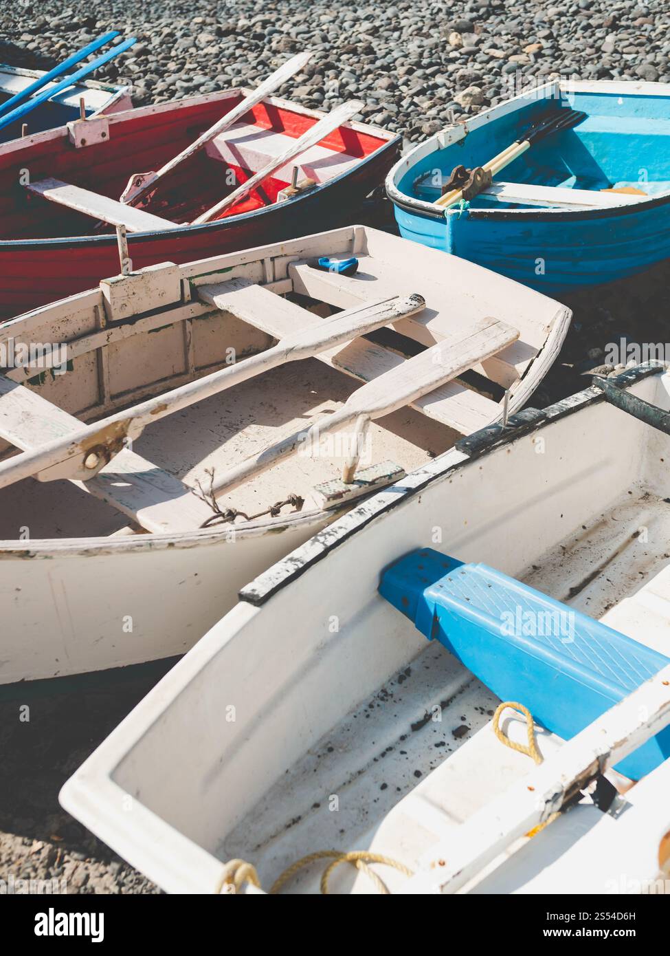 Toned photo of vintage wooden rowing boats on the ocean coast. Toned ...