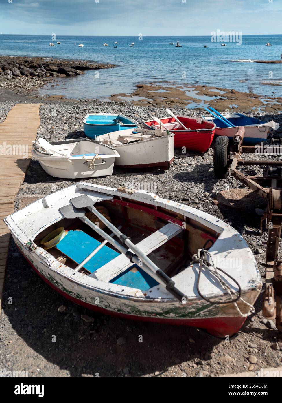 Image of old painted wooden rowing boats lying on the sea beach next to ...