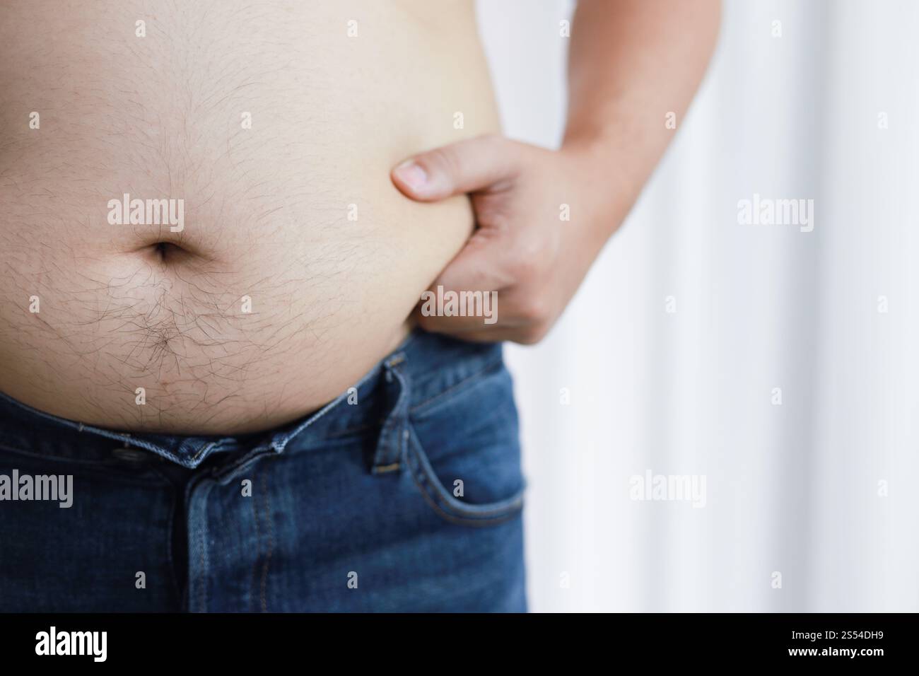 Man with fat belly in dieting concept. Overweight man touching his fat ...
