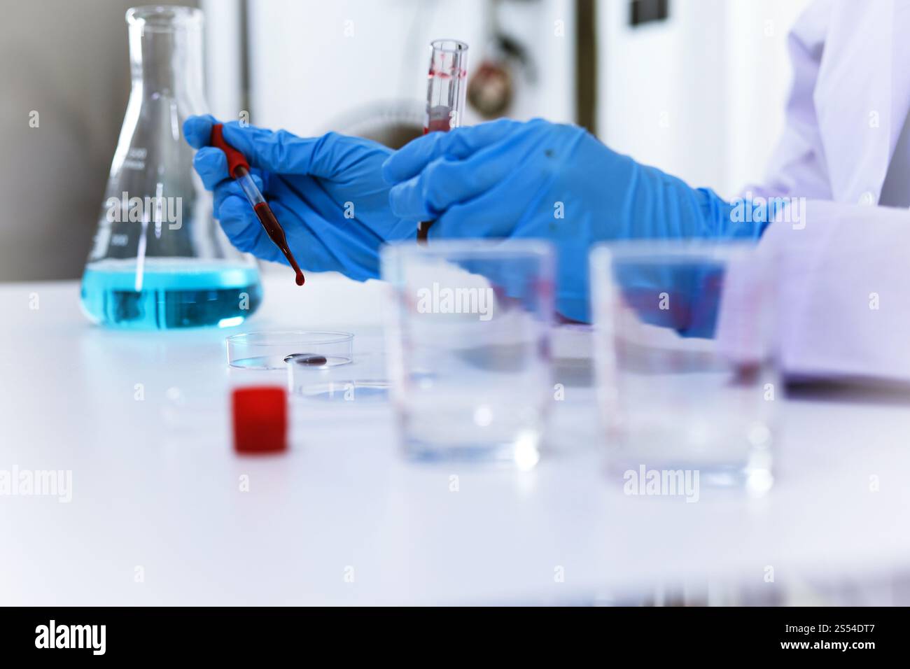 Scientist holding Coronavirus covid-19 infected blood sample tube. DNA ...